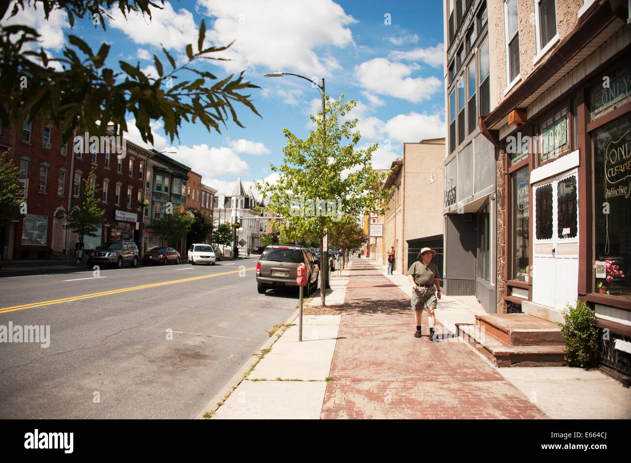 Man walking on sidewalk Stock Photo - Alamy