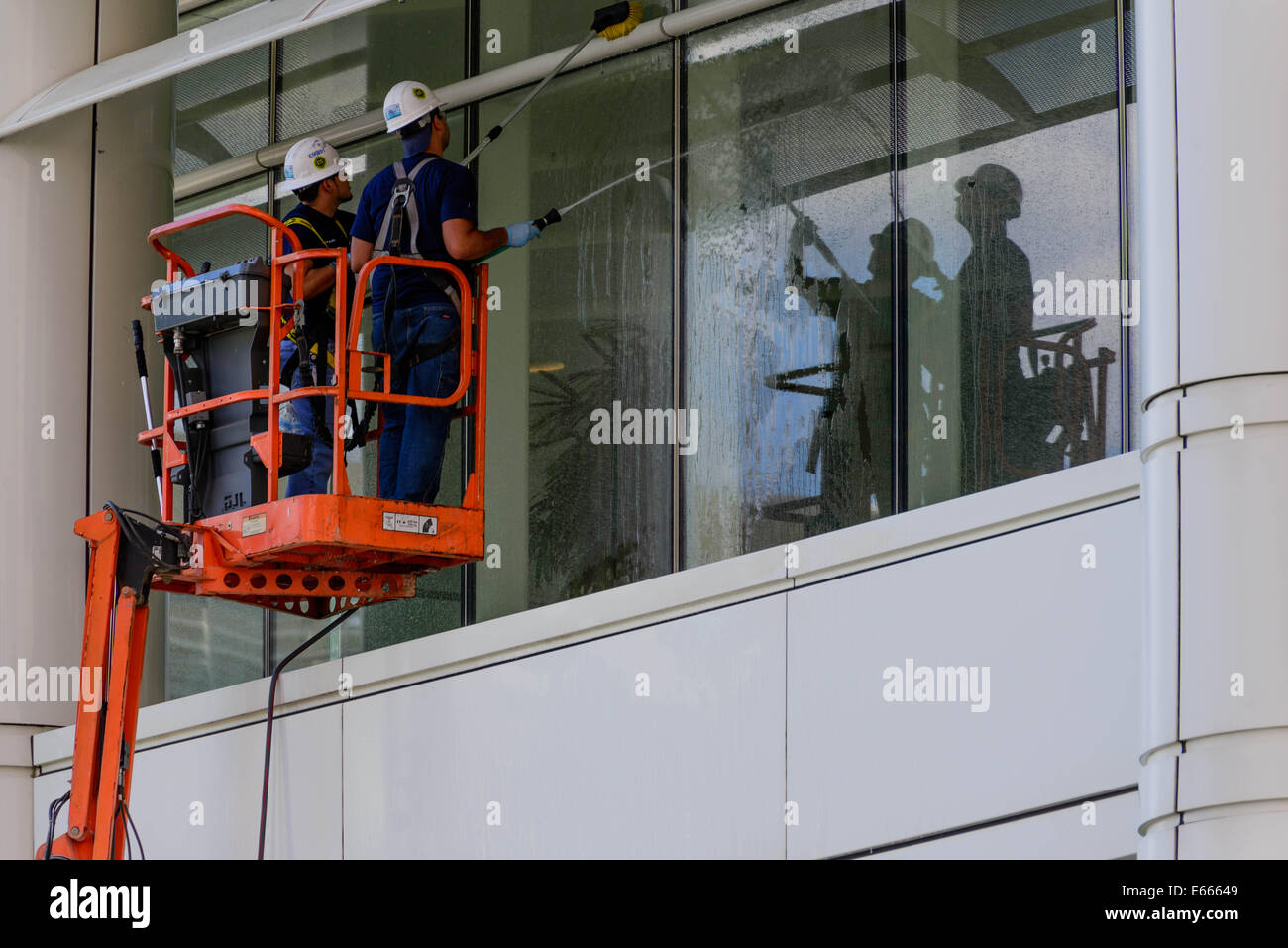 window washing crew on a lift Stock Photo - Alamy