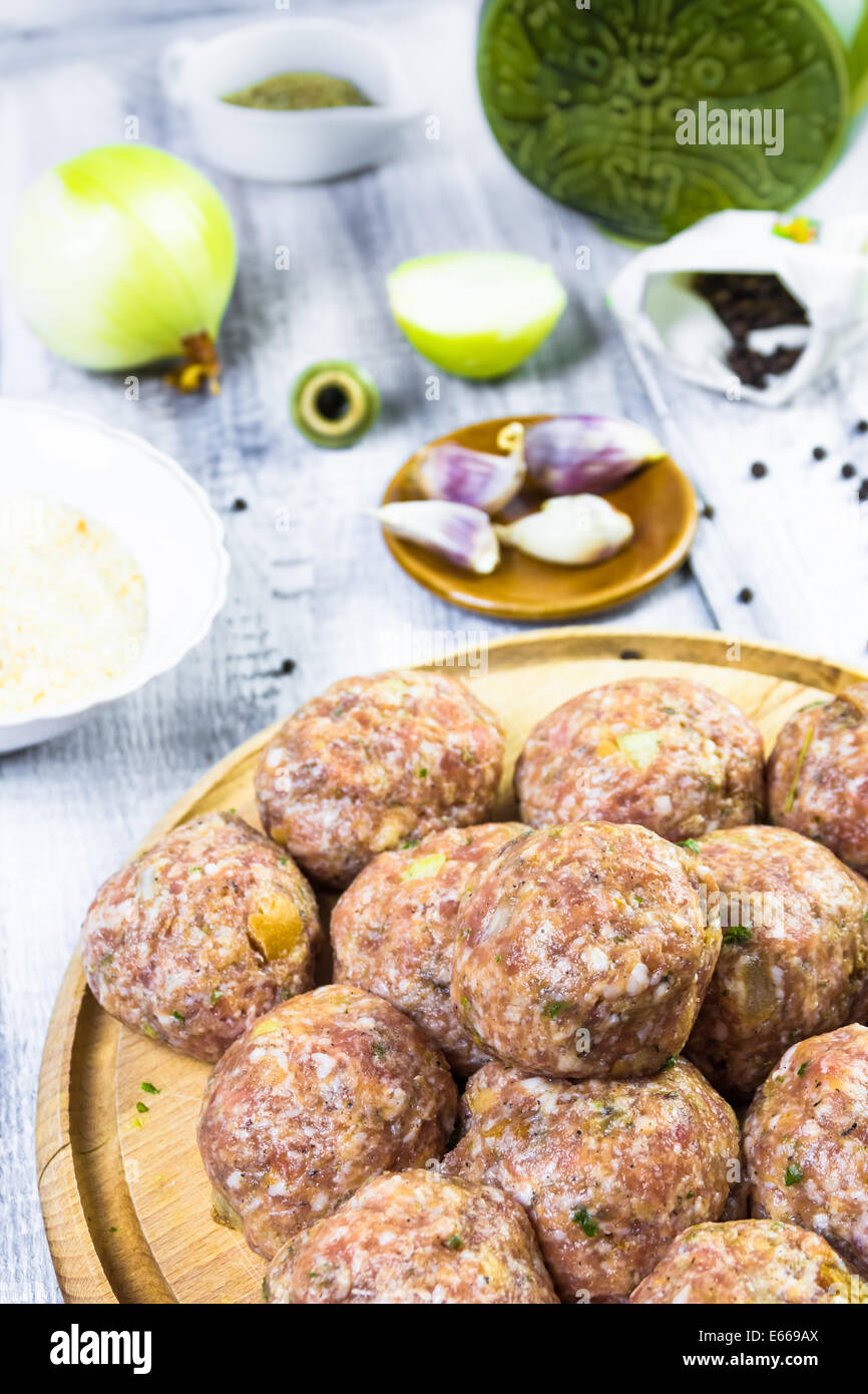 Closeup of meatballs prepared for roll in breadcrumbs Stock Photo - Alamy