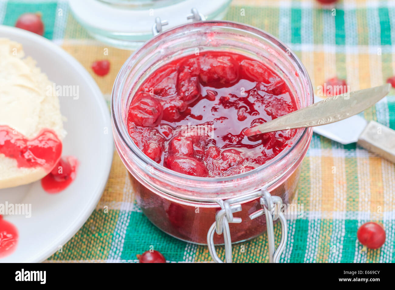 Scooping gooseberry jam from the jar with a spoon Stock Photo - Alamy