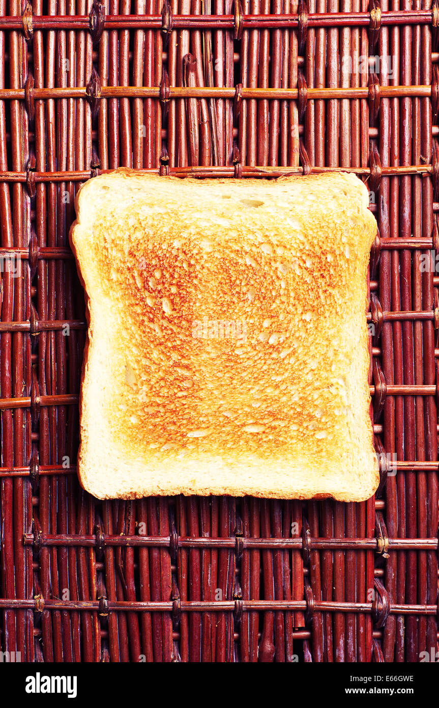 Toast bread on wicker wooden background top view Stock Photo - Alamy