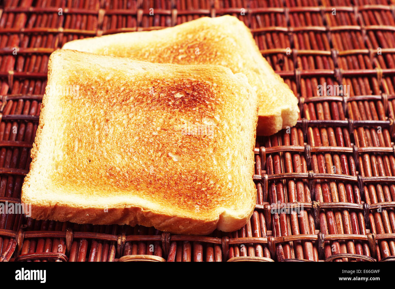 Toast bread on wicker wooden background Stock Photo - Alamy