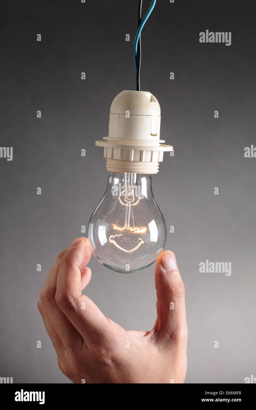 human hand changing a light bulb Stock Photo - Alamy