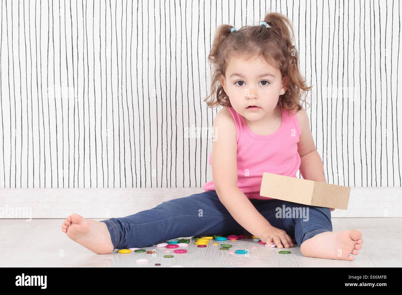 happy girl playing with some buttons Stock Photo - Alamy