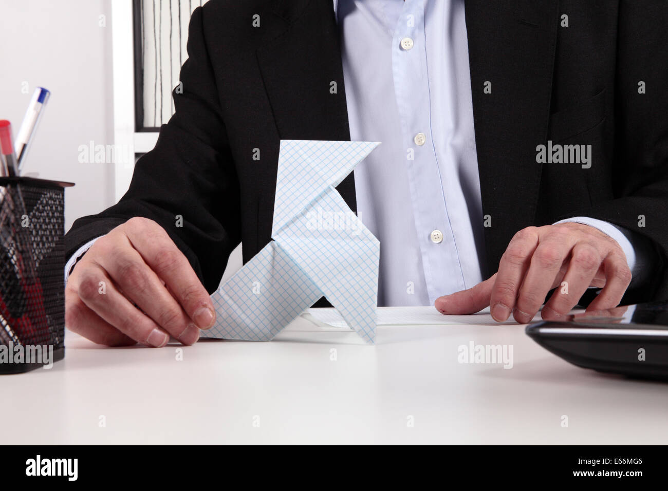 worker wasting time with origami Stock Photo - Alamy