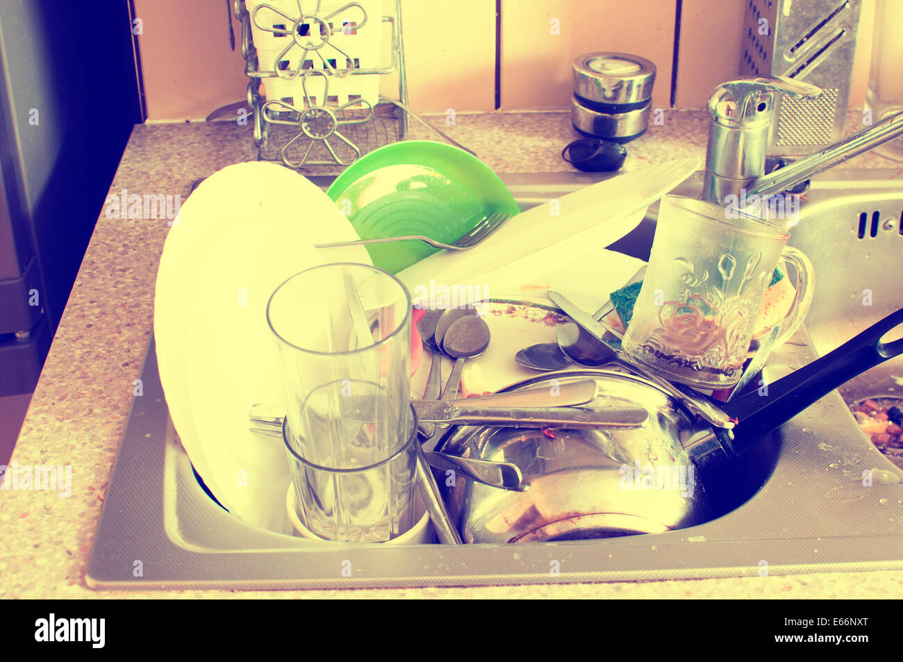 Dishes in the sink - mess in the kitchen Stock Photo - Alamy