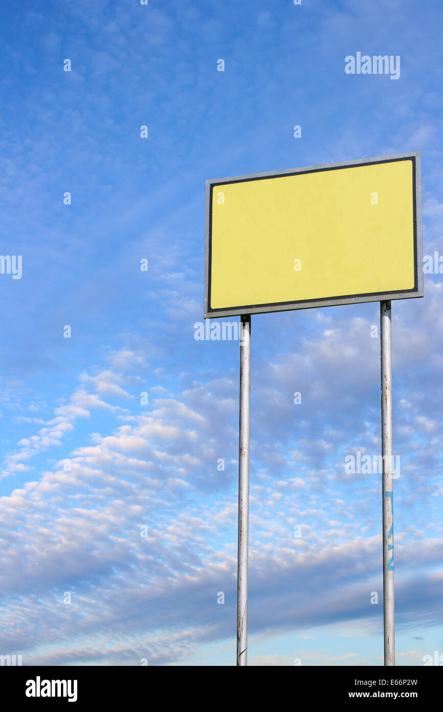 Small blank sign against deep blue sky background Stock Photo - Alamy