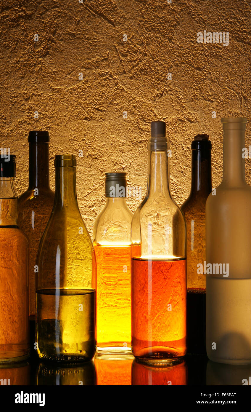 Lots bottles of alcohol drinks over textured background Stock Photo - Alamy