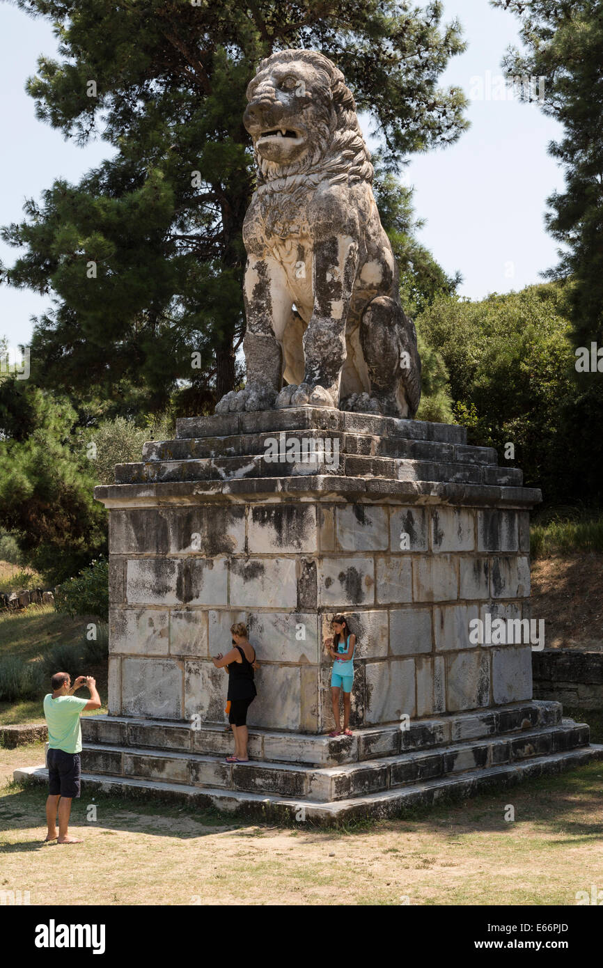 Tourists takes pictures of a 4th century BC marble Lion of Amphipolis ...