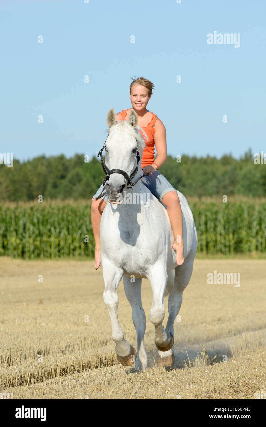 Woman riding grey horse bareback hi-res stock photography and images ...