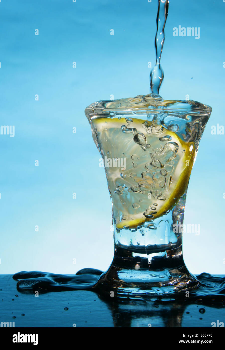 Short glass of alcoholic beverage with lemon slice Stock Photo - Alamy