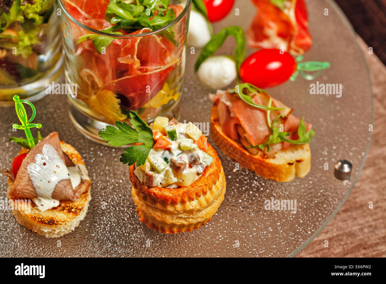 Restaurant food in the form of snacks, sandwiches and canapes closeup ...