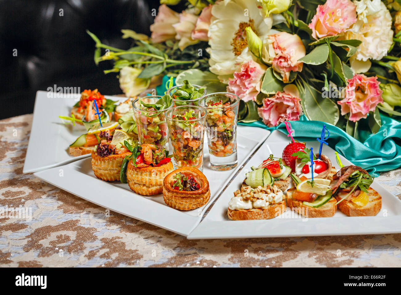 Restaurant food in the form of snacks, sandwiches and canapes closeup ...