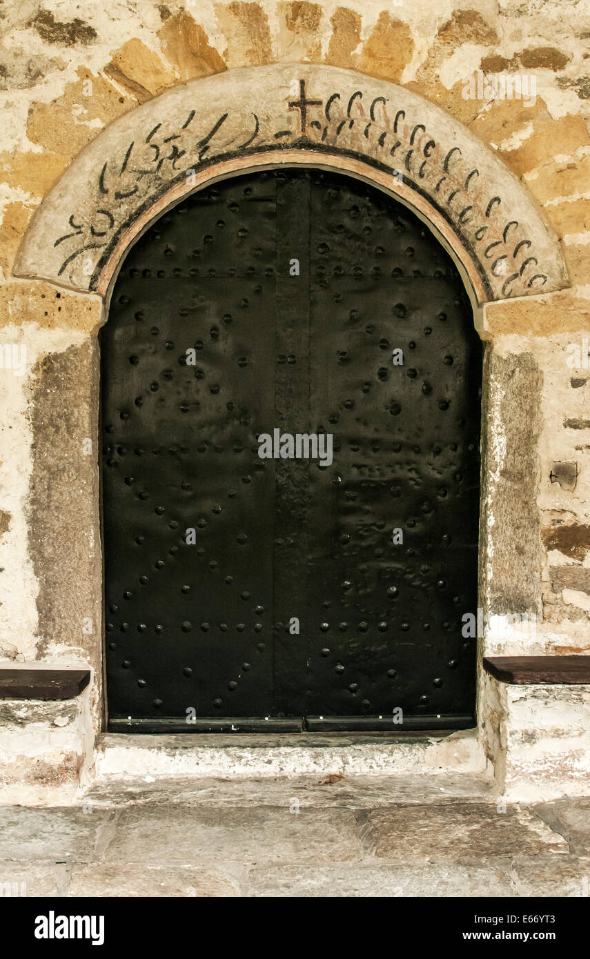 Old metal orthodox church side black door Stock Photo - Alamy