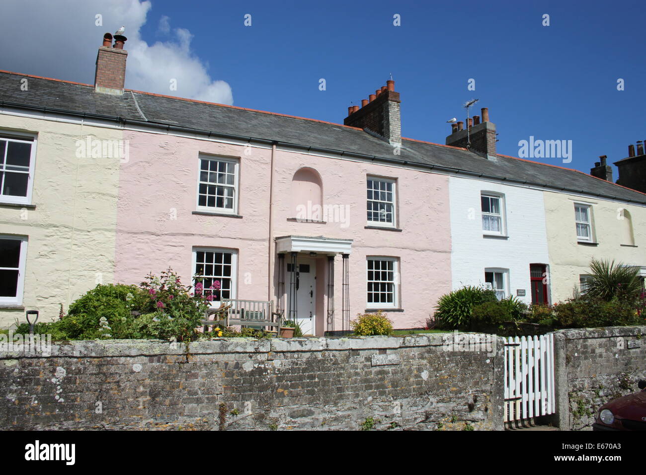 Cornwall pink cottage in row of multi coloured cottages hi-res stock ...