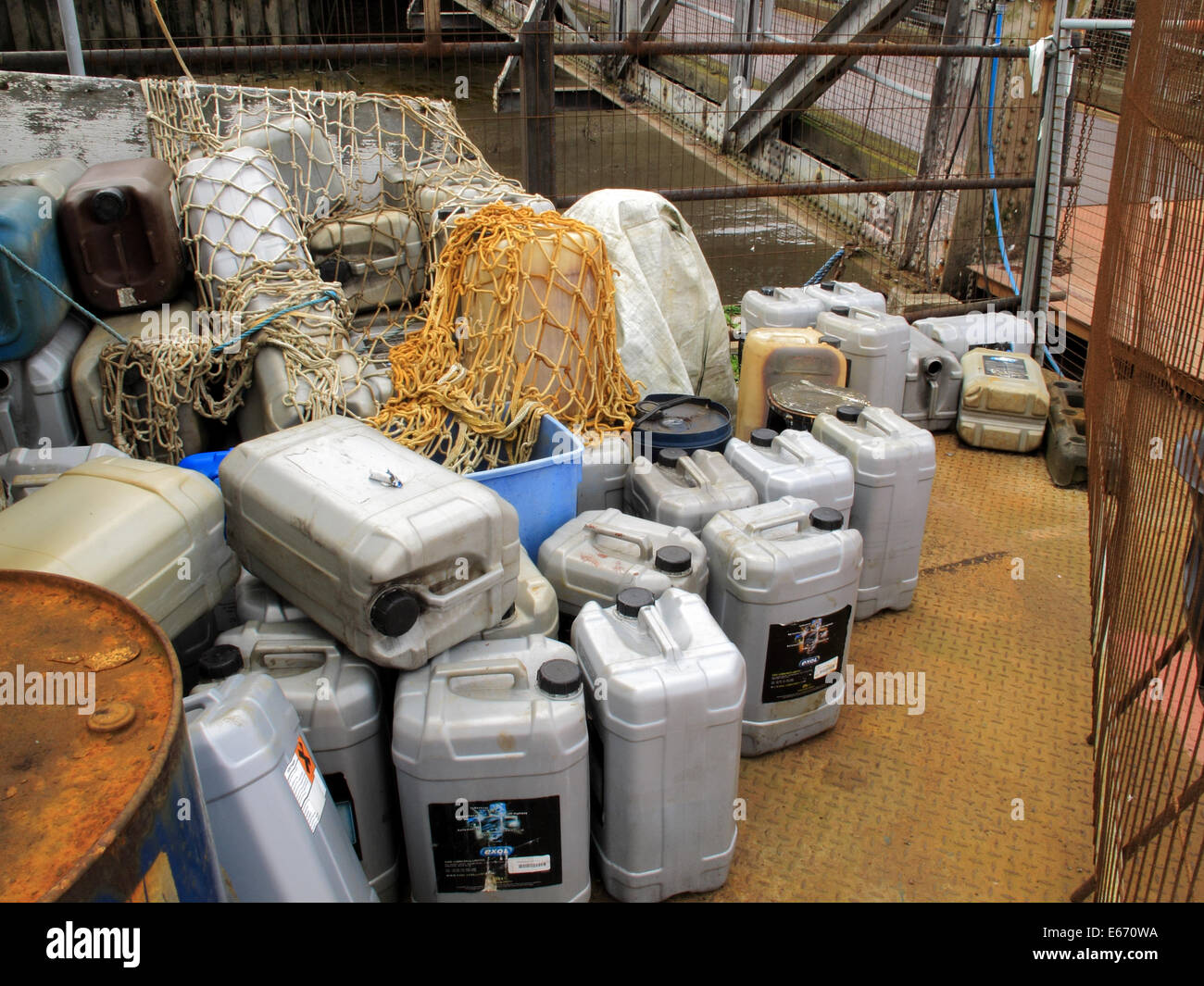 A store of old plastic containers covered by netting Stock Photo - Alamy