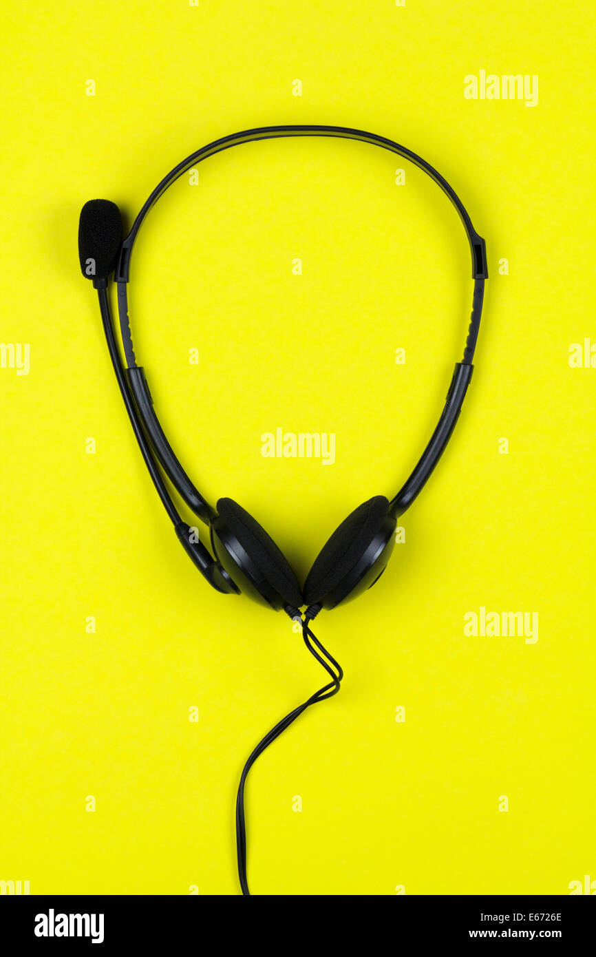 Microphone headset/headphones on a solid yellow background Stock Photo ...