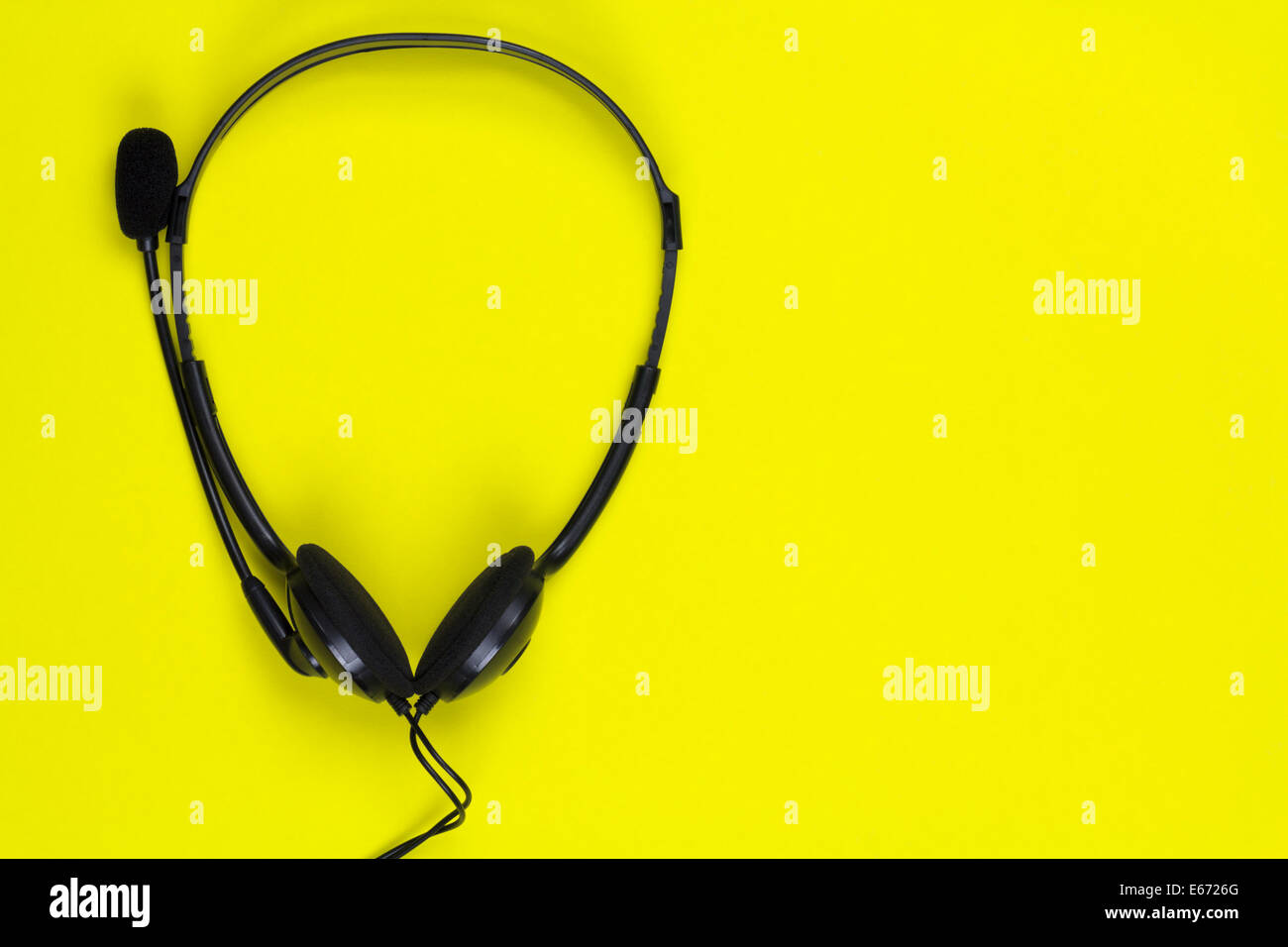 Microphone headset/headphones on a solid yellow background Stock Photo ...