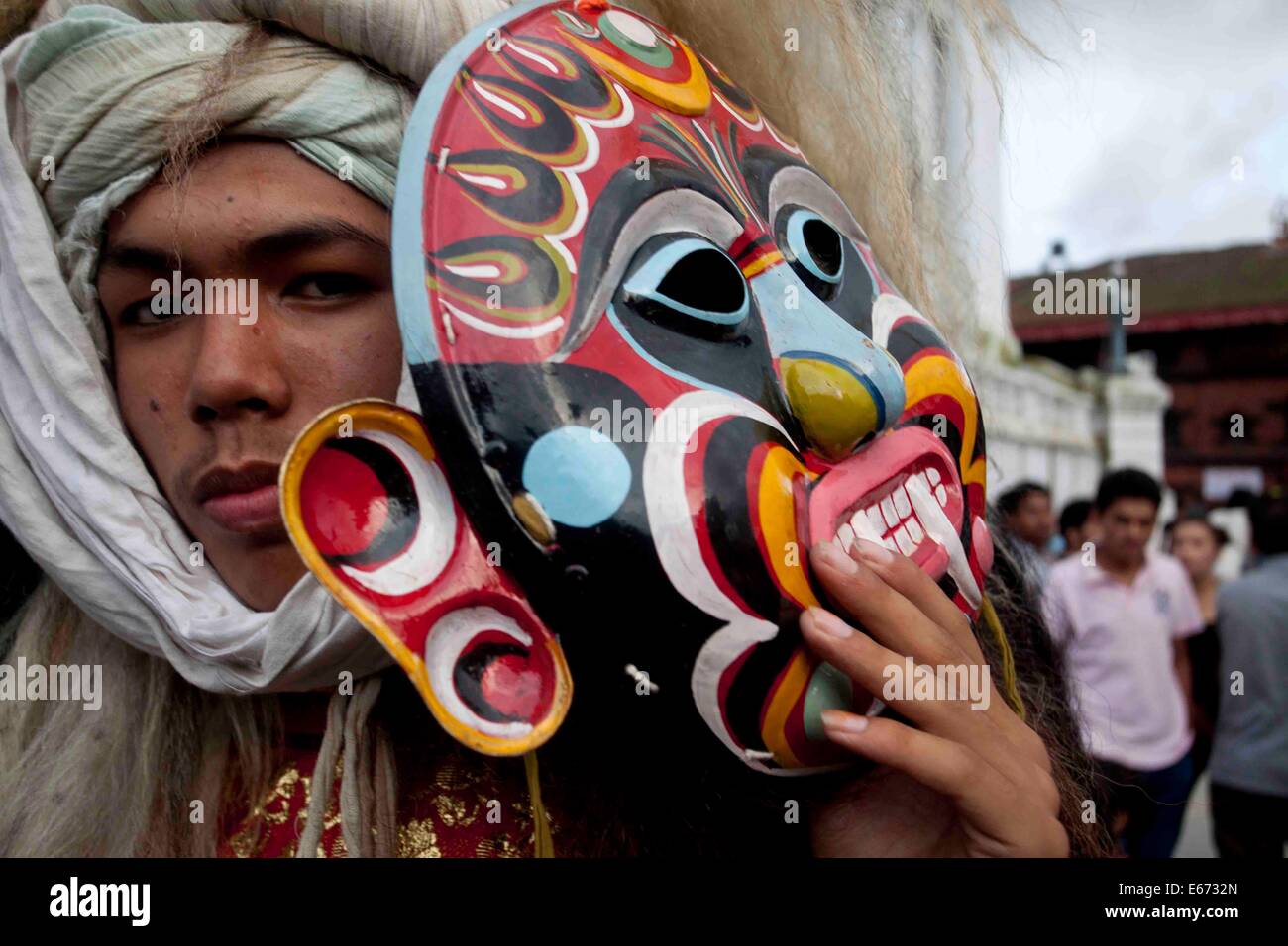 Kathmandu, Nepal. 16th Aug, 2014. A Newari in traditional costume holds ...
