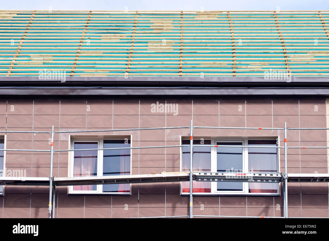 roof repair construction and scaffold construction near windows Stock ...