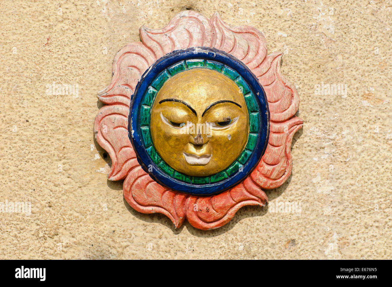 sun symbol colorful retro mask on asia house wall Stock Photo - Alamy