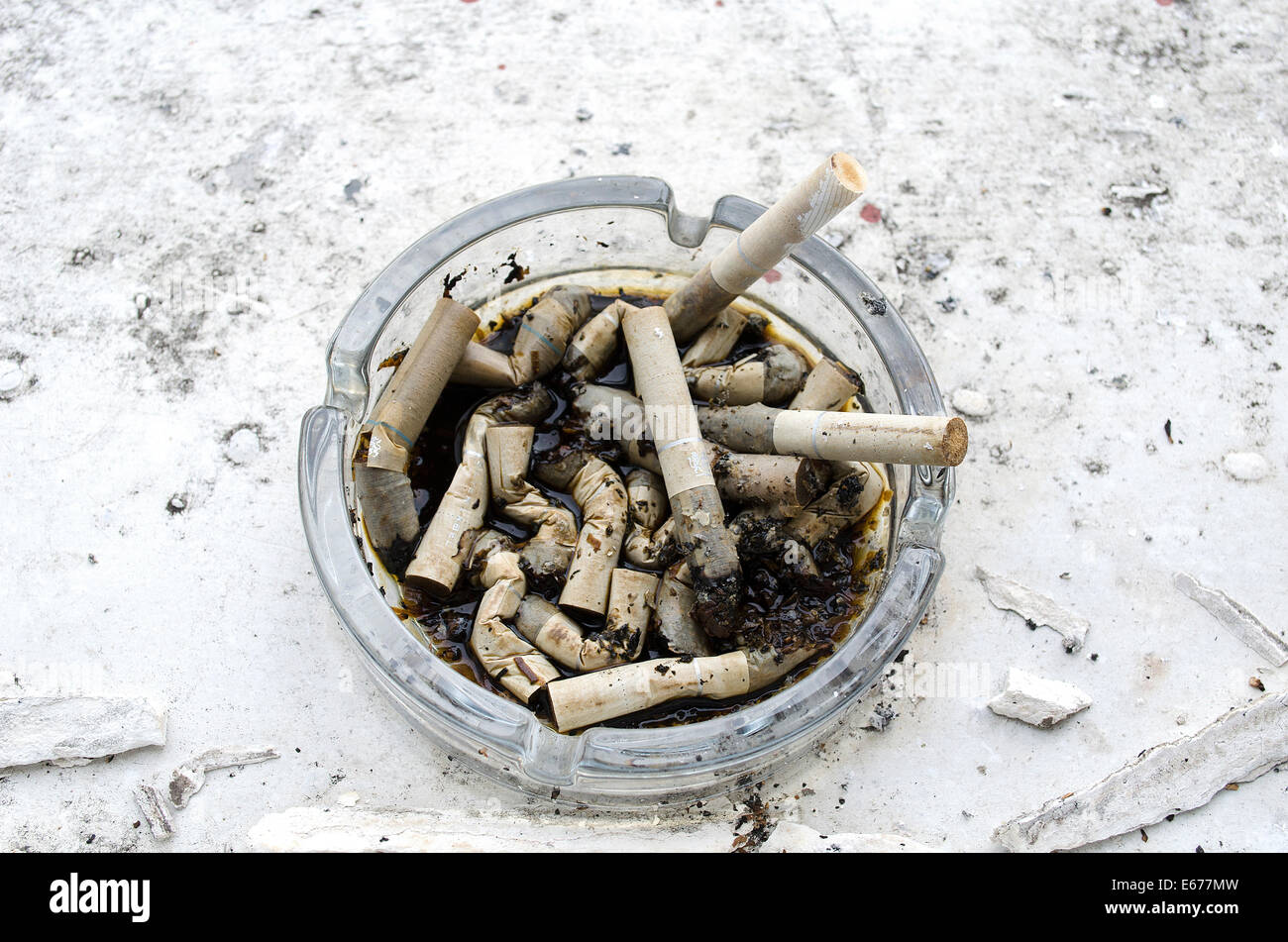 Ashtray Full of Cigarettes burnt butts wet and disgusting Stock Photo ...