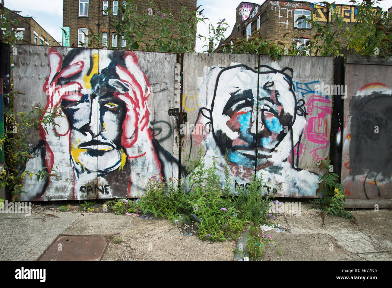 London. Hackney Wick. Street art and weeds in front of artists studios ...