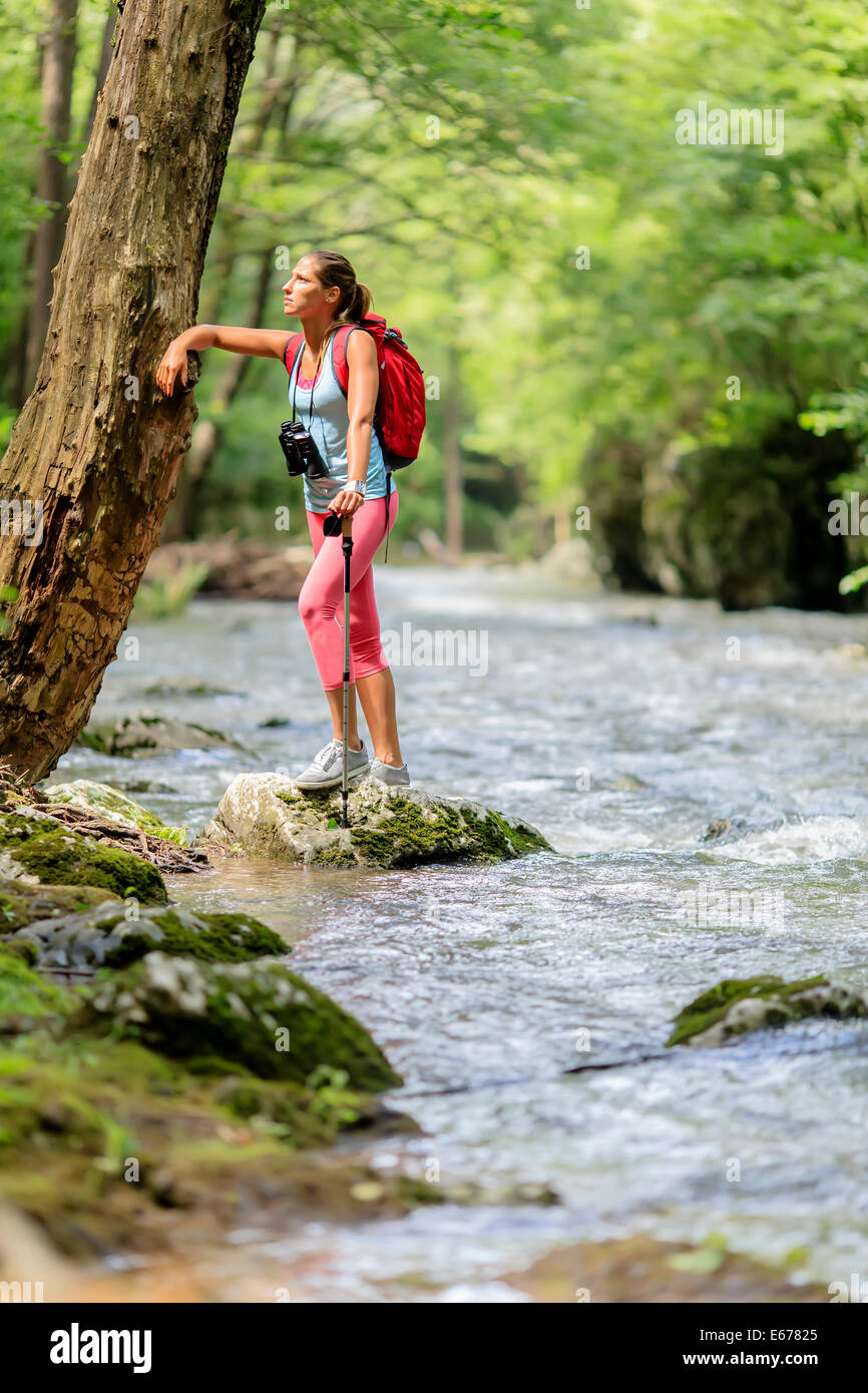 Young woman hiking in the forest Stock Photo - Alamy