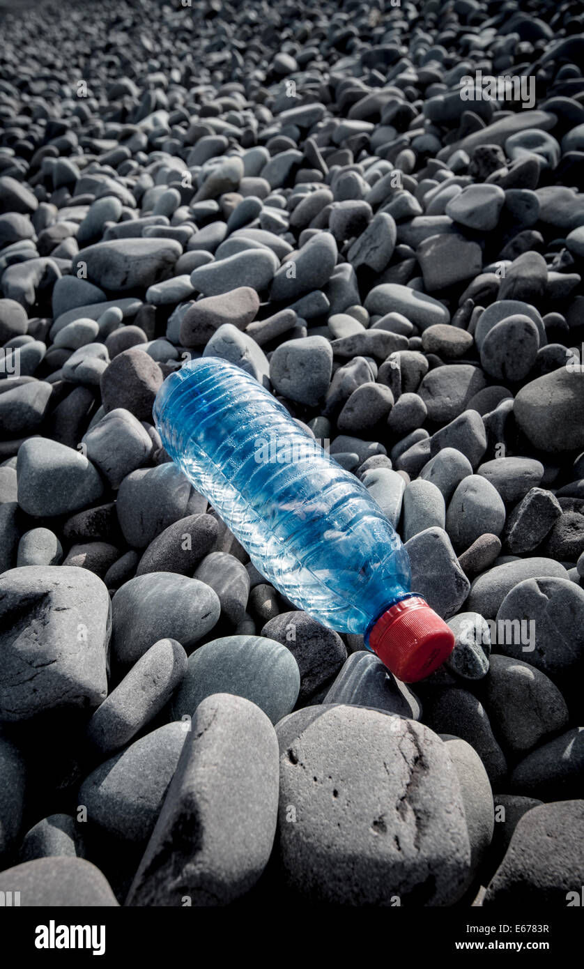A plastic bottle discarded on a pebble beach Stock Photo - Alamy