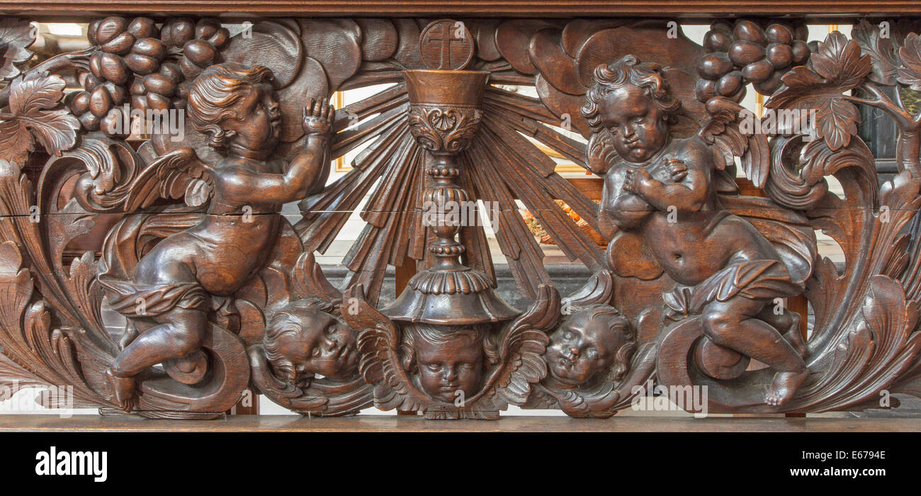 BRUGES, BELGIUM - JUNE 13, 2014: Carved relief of angel and cup as the ...