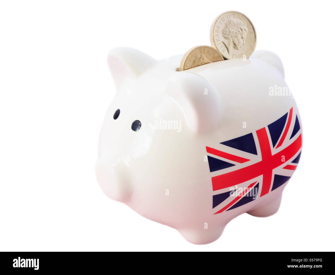 Piggy bank with British Union Jack and sterling pound coins in slot to ...