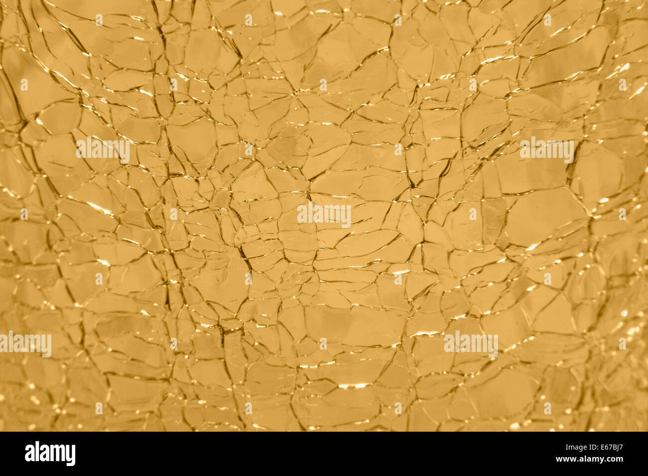 abstract full frame background of cracked glass, gold toned Stock Photo ...