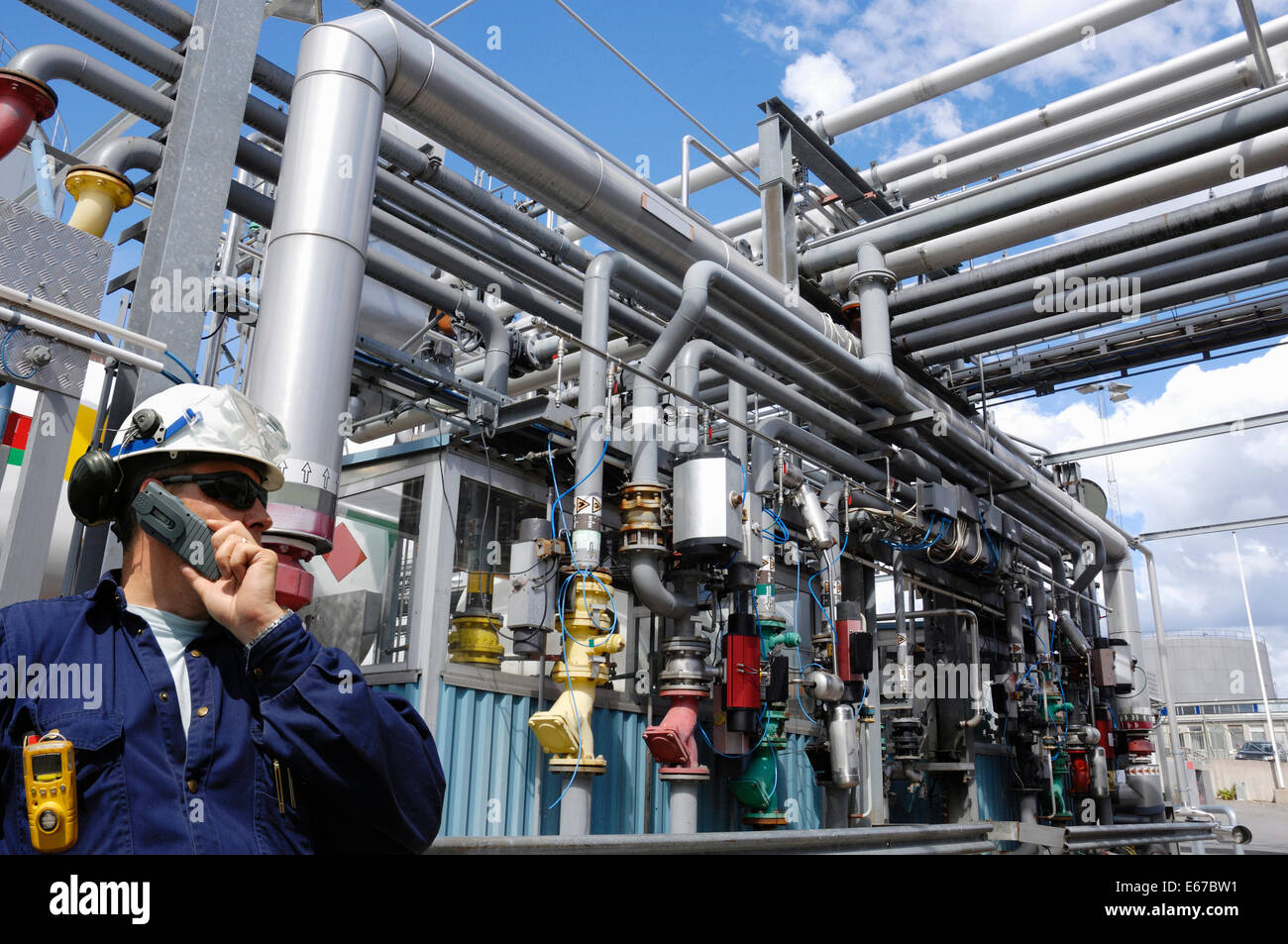 refinery worker and giant pipelines Stock Photo - Alamy