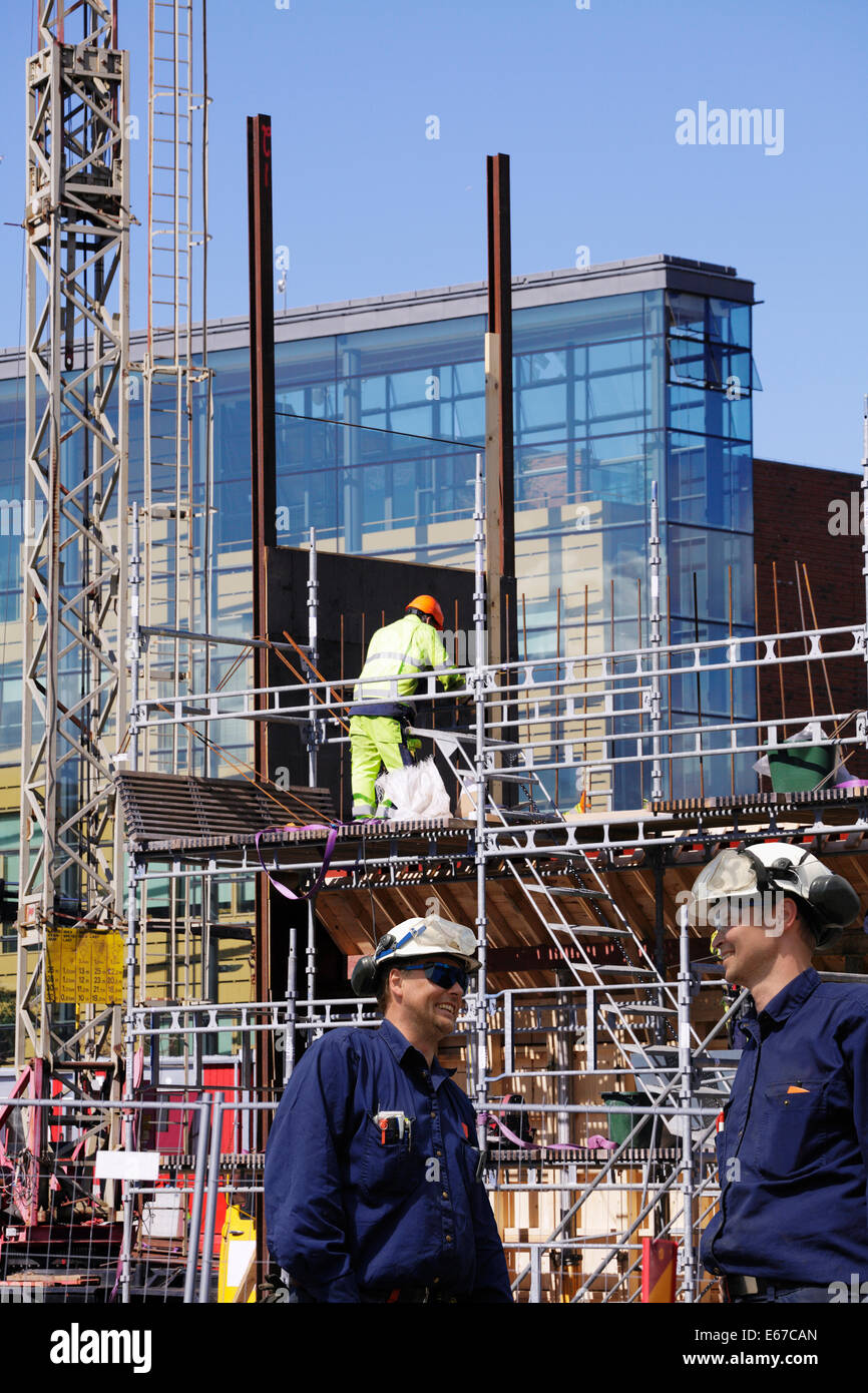two building workers with construction site in background Stock Photo ...