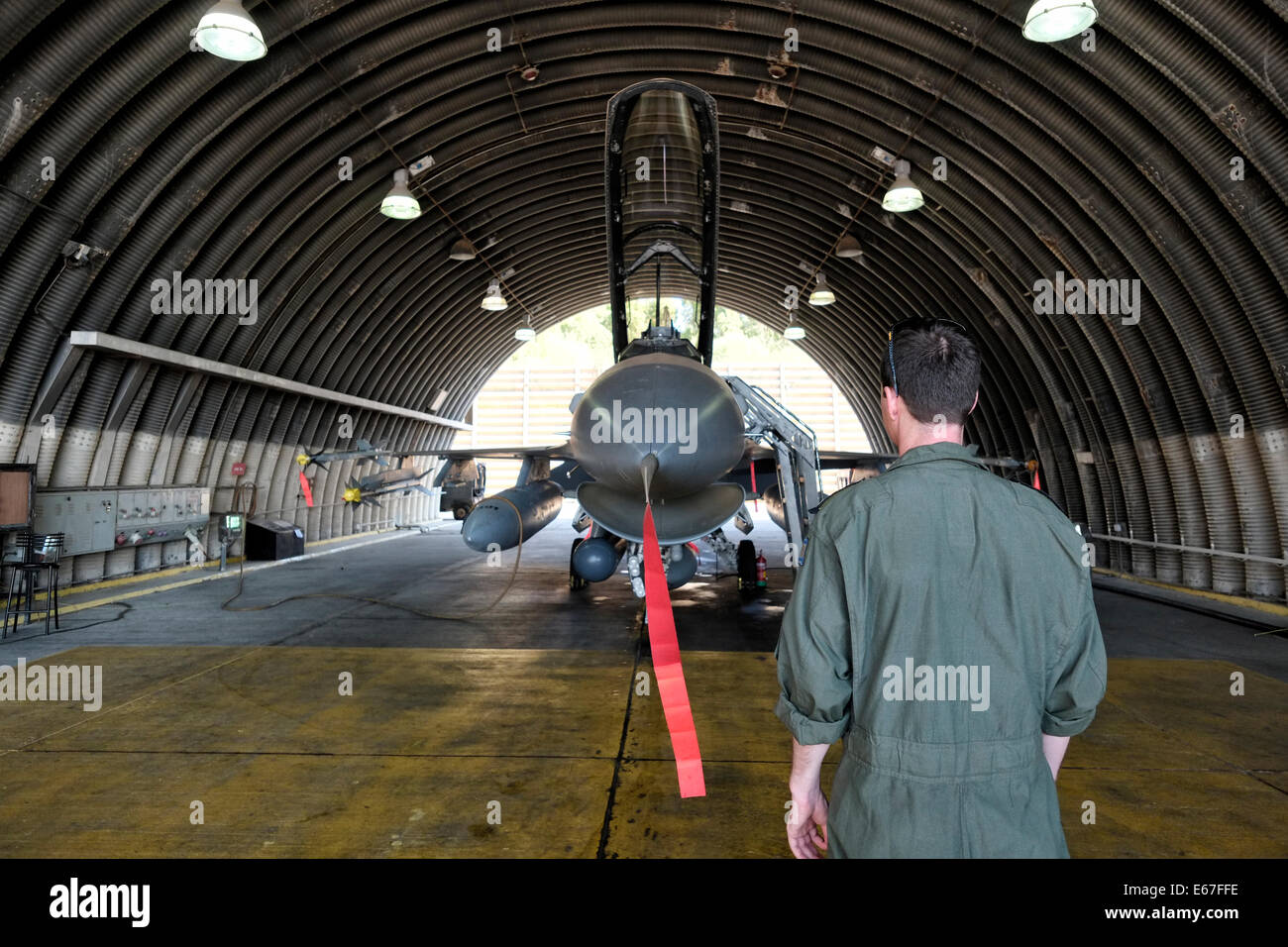 An Israeli pilot with a F-16 fighter jet in a hangar at Hatzor Israeli ...