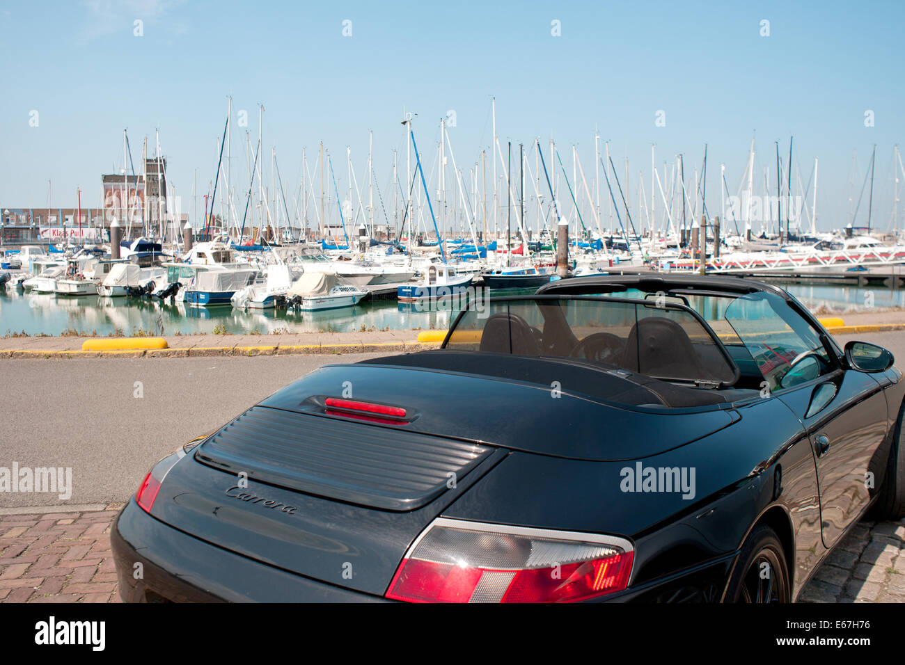 convertible sports car with marina in the background Stock Photo - Alamy