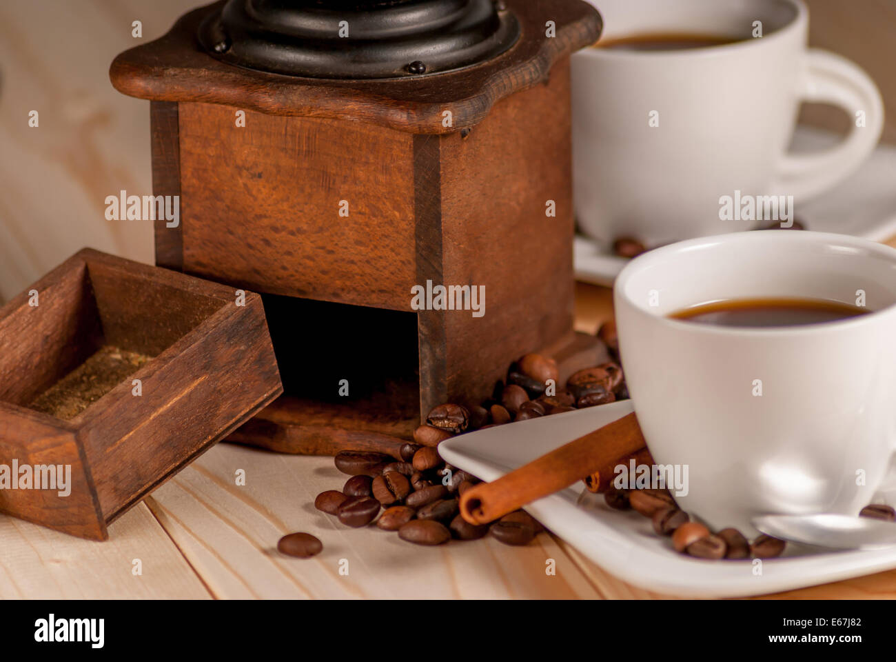 Cup of coffee and cinnamon and ancient grinder Stock Photo - Alamy