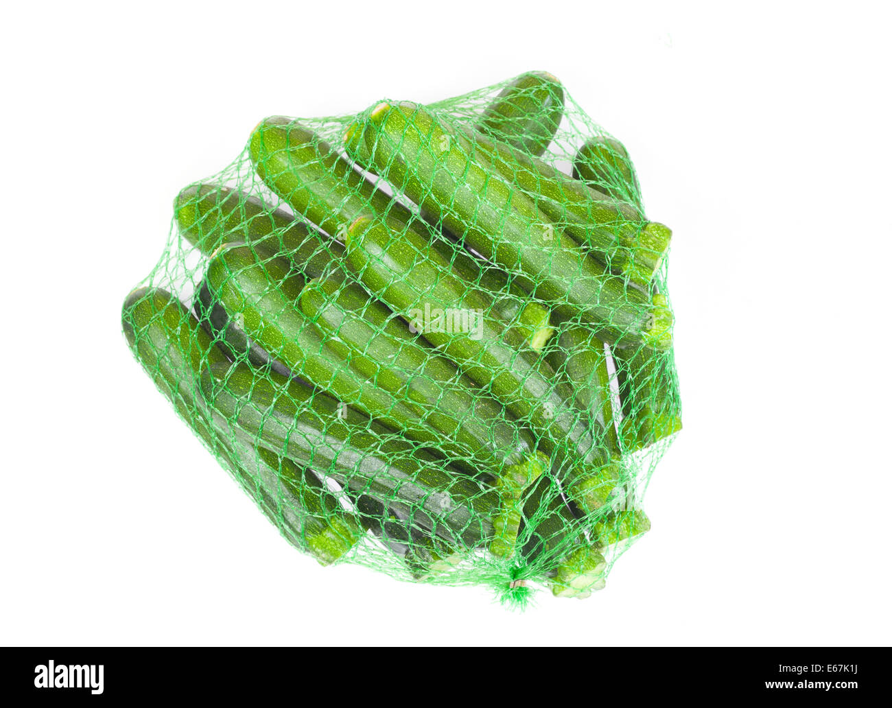 Courgettes in a string bag on a white background Stock Photo - Alamy