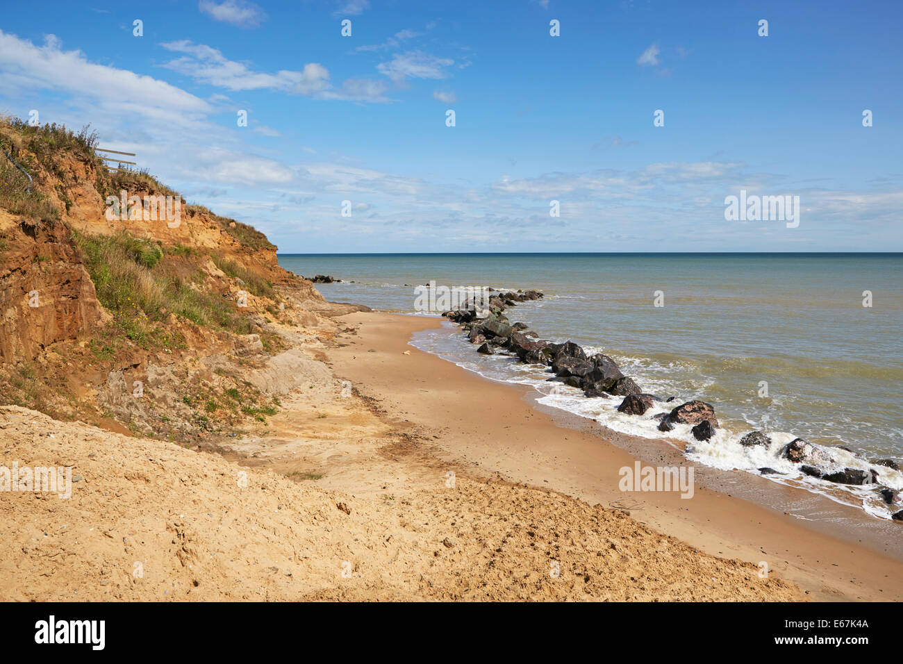 Happisburgh beach North Norfolk showing collapsing cliffs and boulders ...