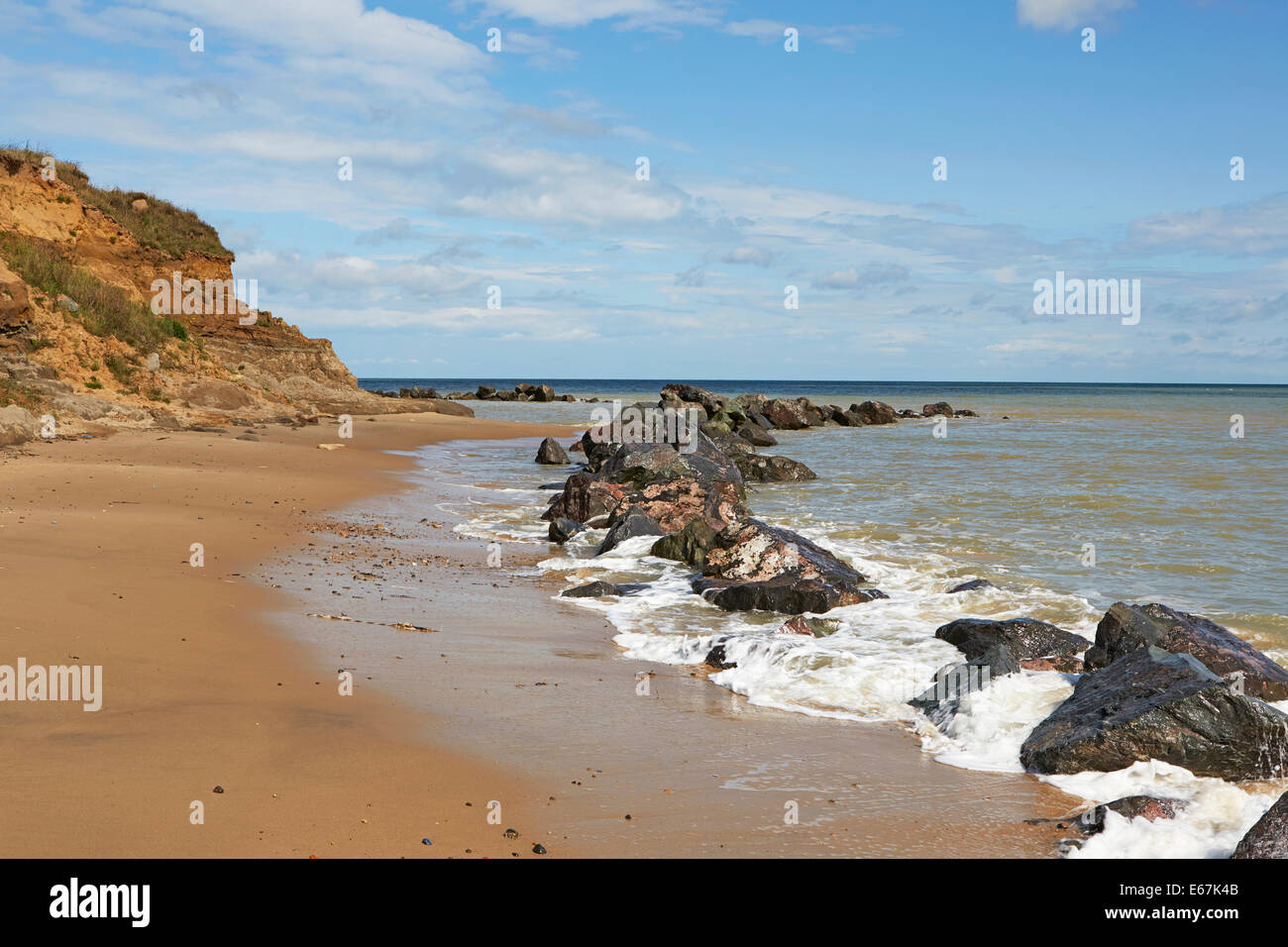 Happisburgh beach North Norfolk showing collapsing cliffs and boulders ...