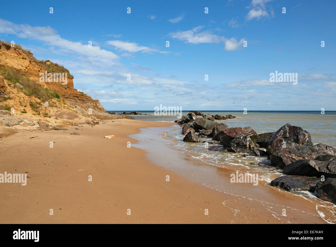Happisburgh beach North Norfolk showing collapsing cliffs and boulders ...