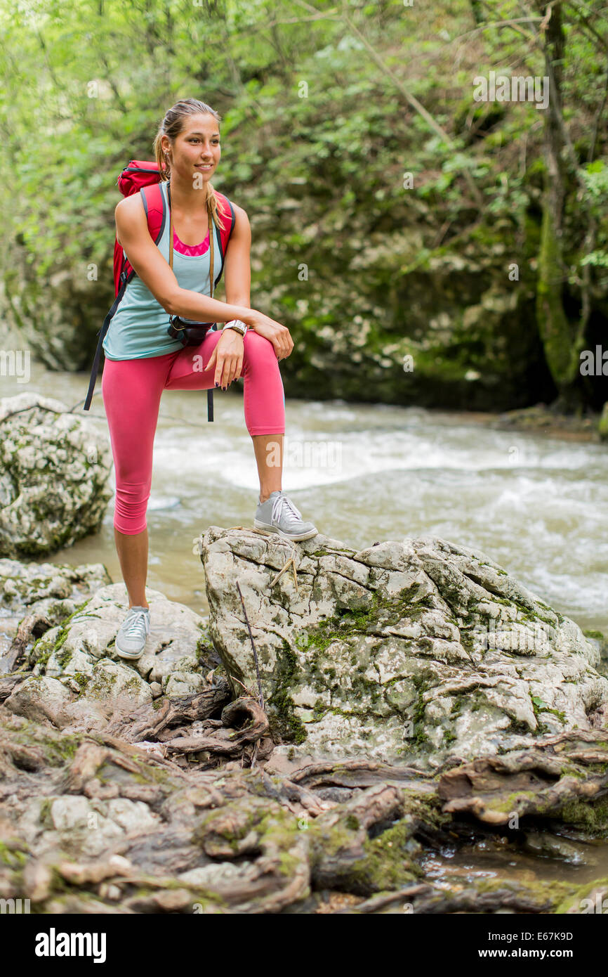 Young woman hiking in the forest Stock Photo - Alamy