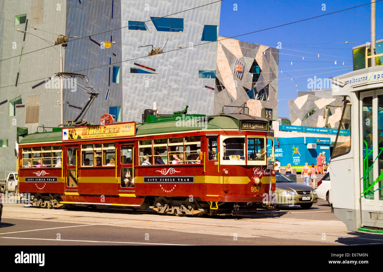 Deep traditional maroon red tram travelling along Swanston street in ...