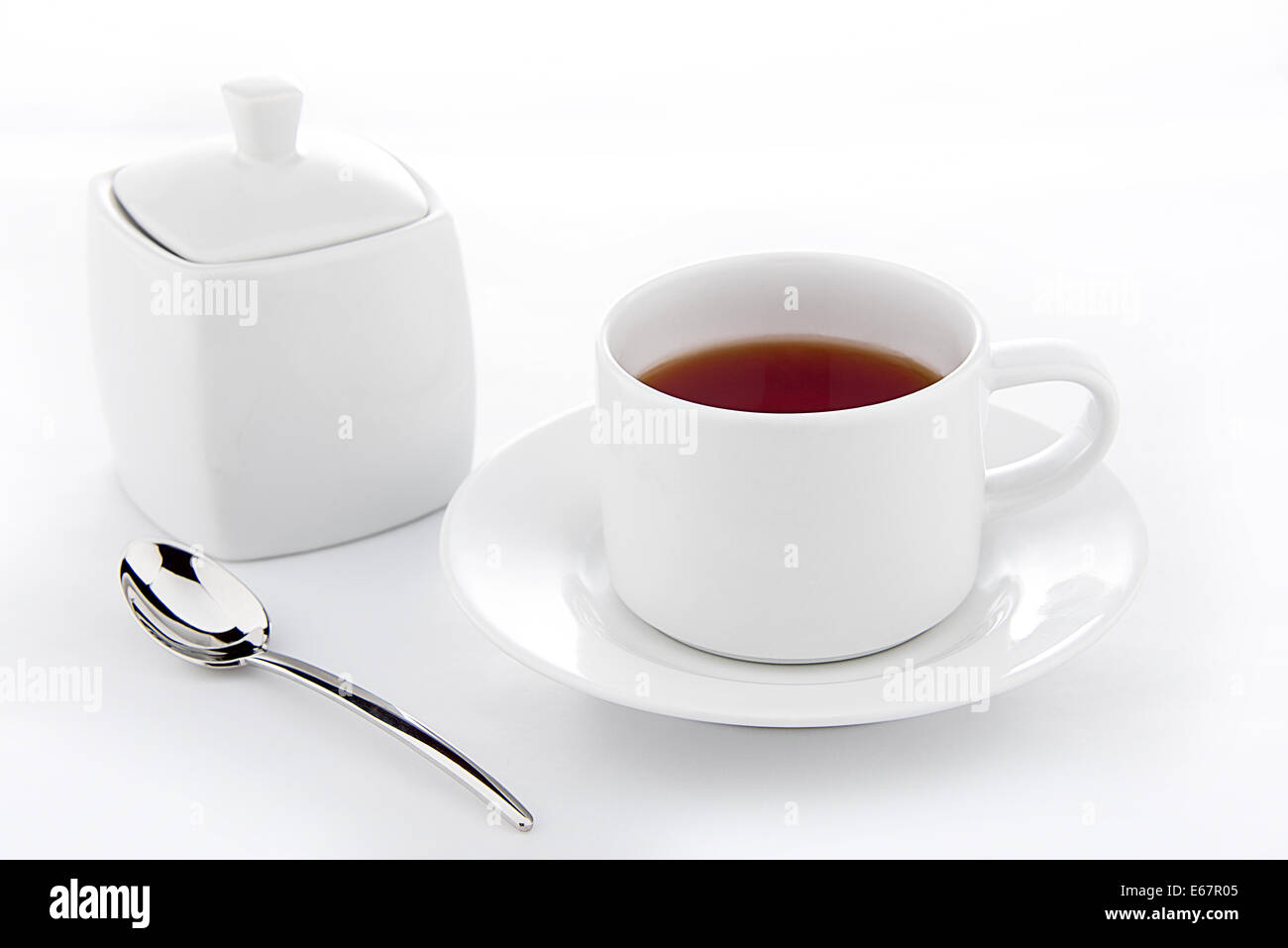 Tea time - a cup of tea with sugar pot and spoon Stock Photo - Alamy