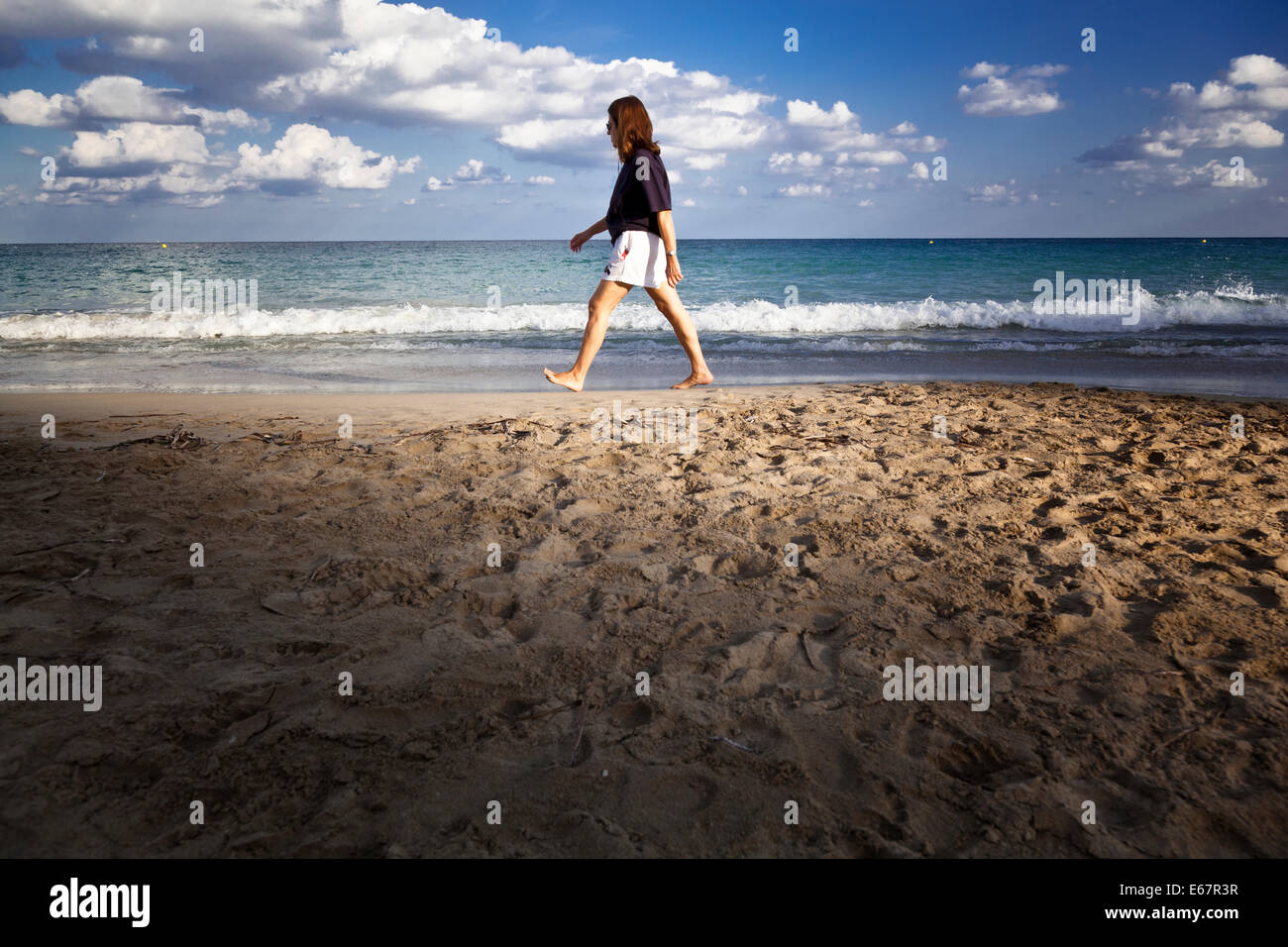 Female walks along beach hi-res stock photography and images - Alamy