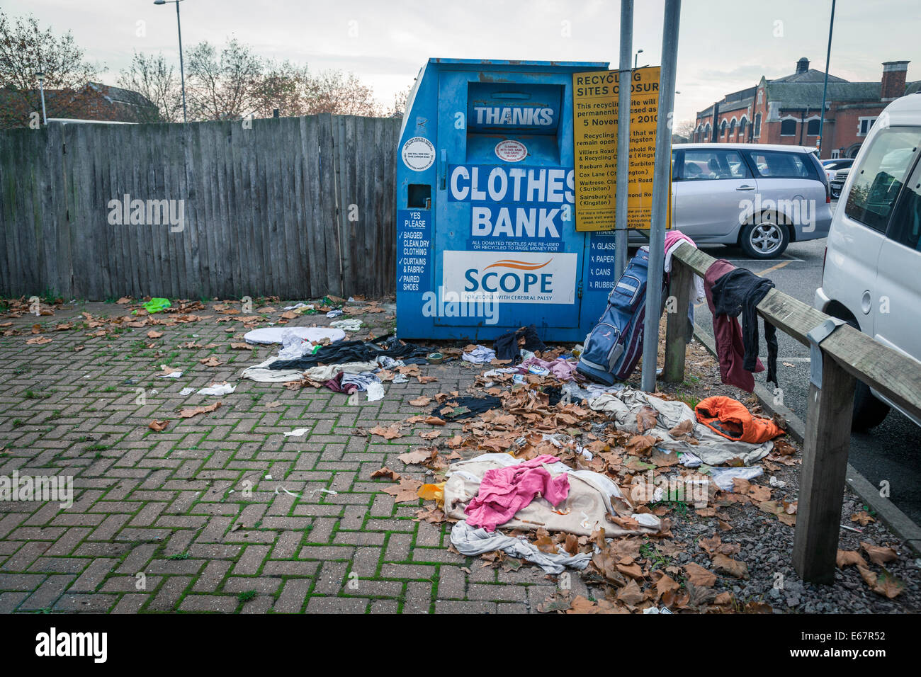 Litter of clothes and other items are mixed with fallen leaves around a ...