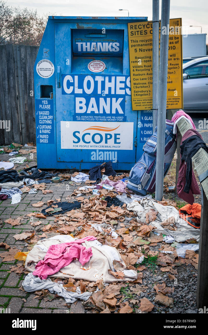Litter of clothes and other items are mixed with fallen leaves around a ...