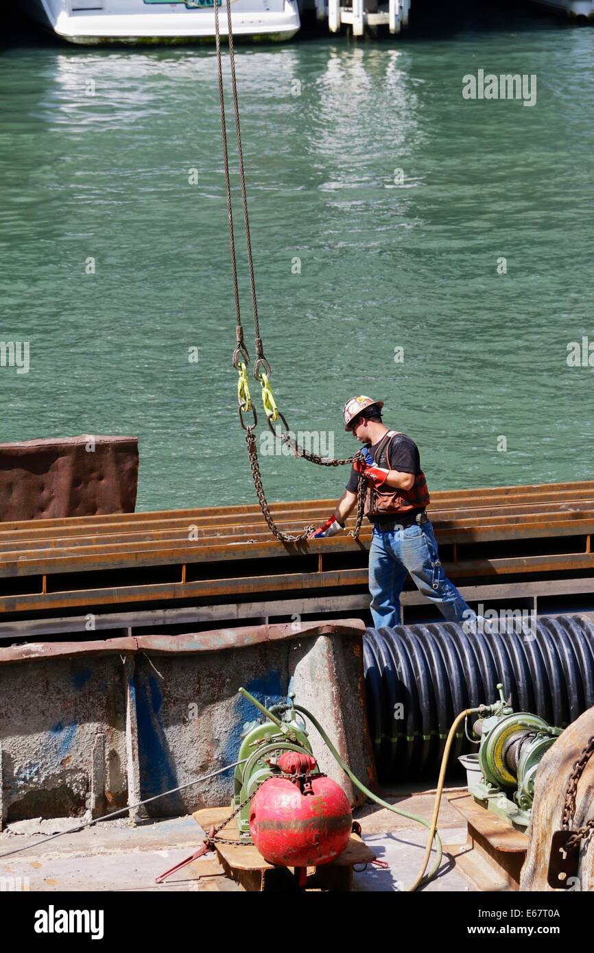 Construction worker on barge, Chicago River Stock Photo - Alamy