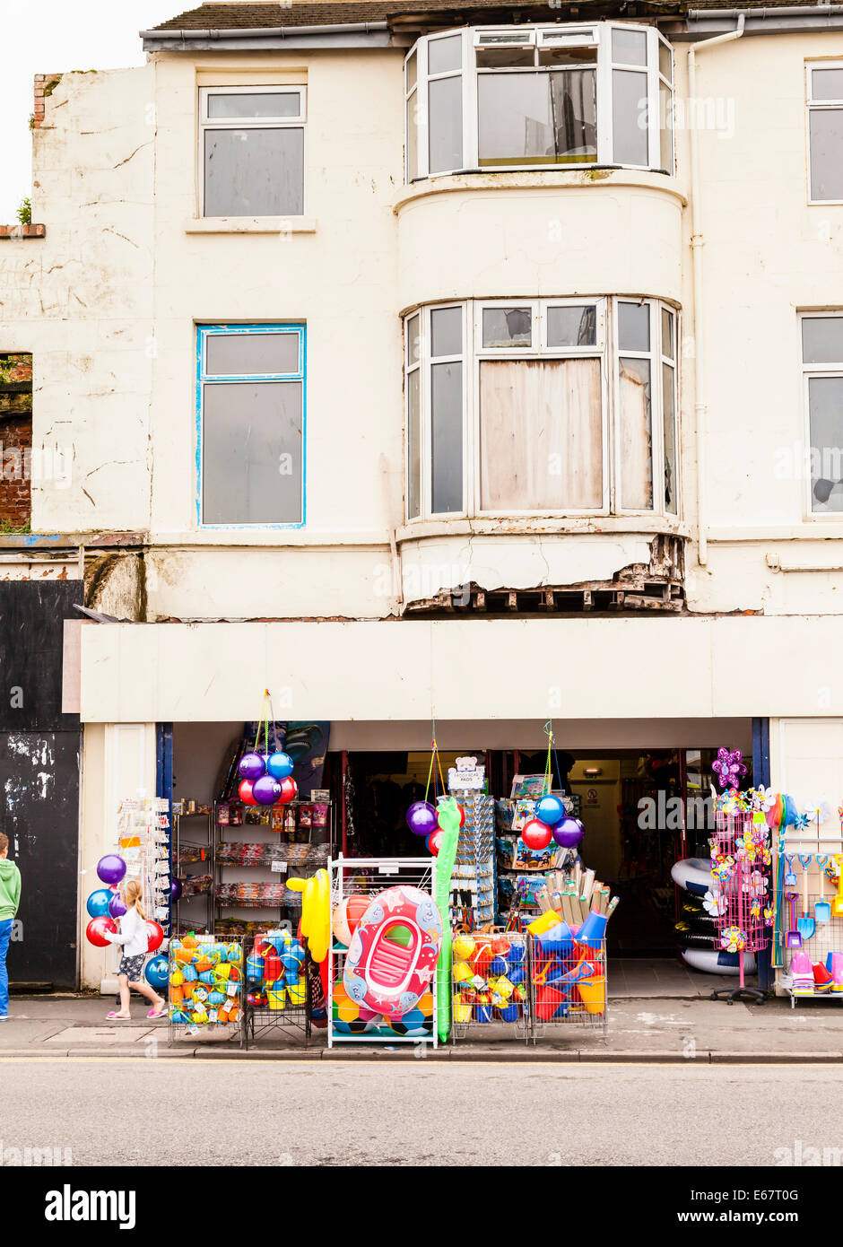 Shop front selling beach toys in disrepair on the promenade, in the ...