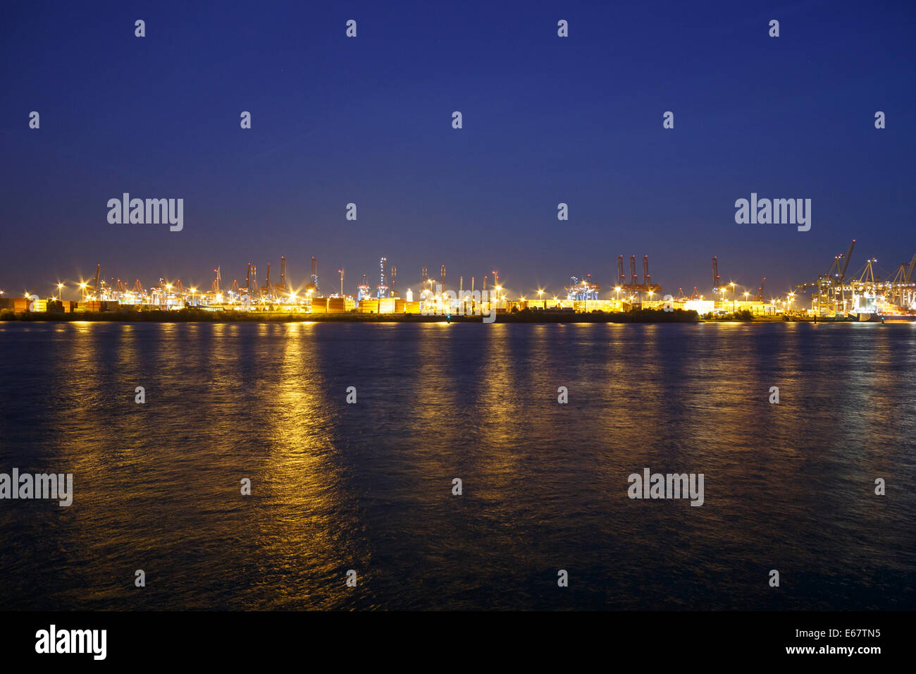 Brightly lit harbor facilities at night in Hamburg, Germany Stock Photo ...
